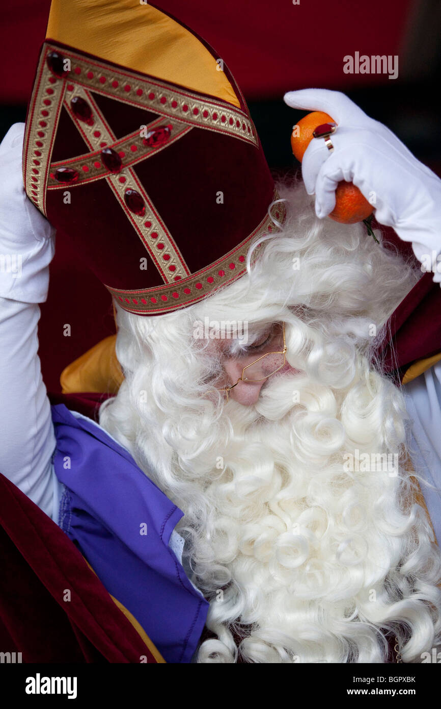 Saint Nicolas puts a hat on Stock Photo - Alamy