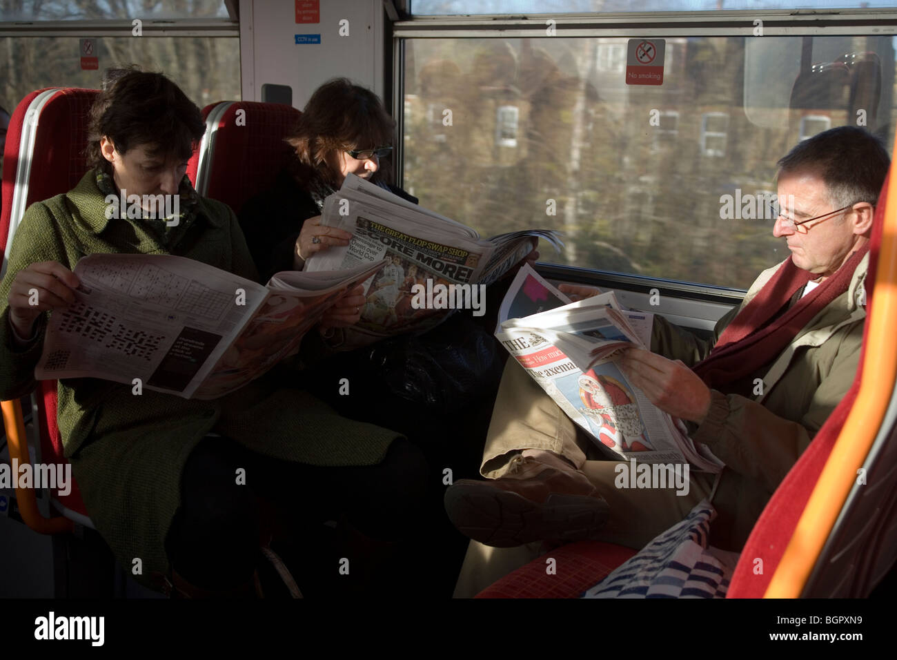 Train passengers reading newspapers hi-res stock photography and images ...