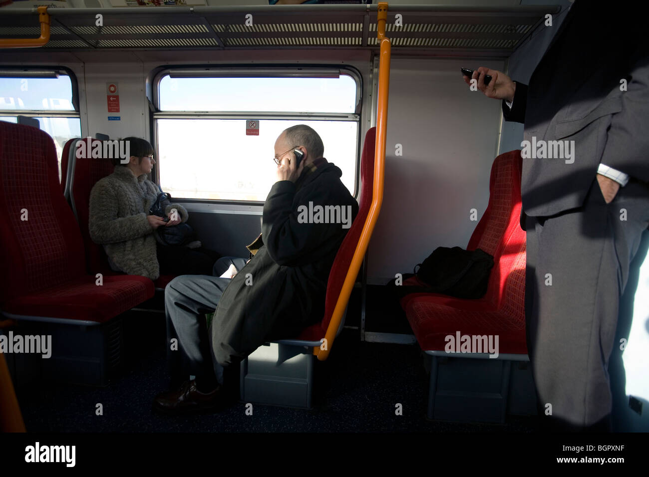 People using phones train hi-res stock photography and images - Alamy