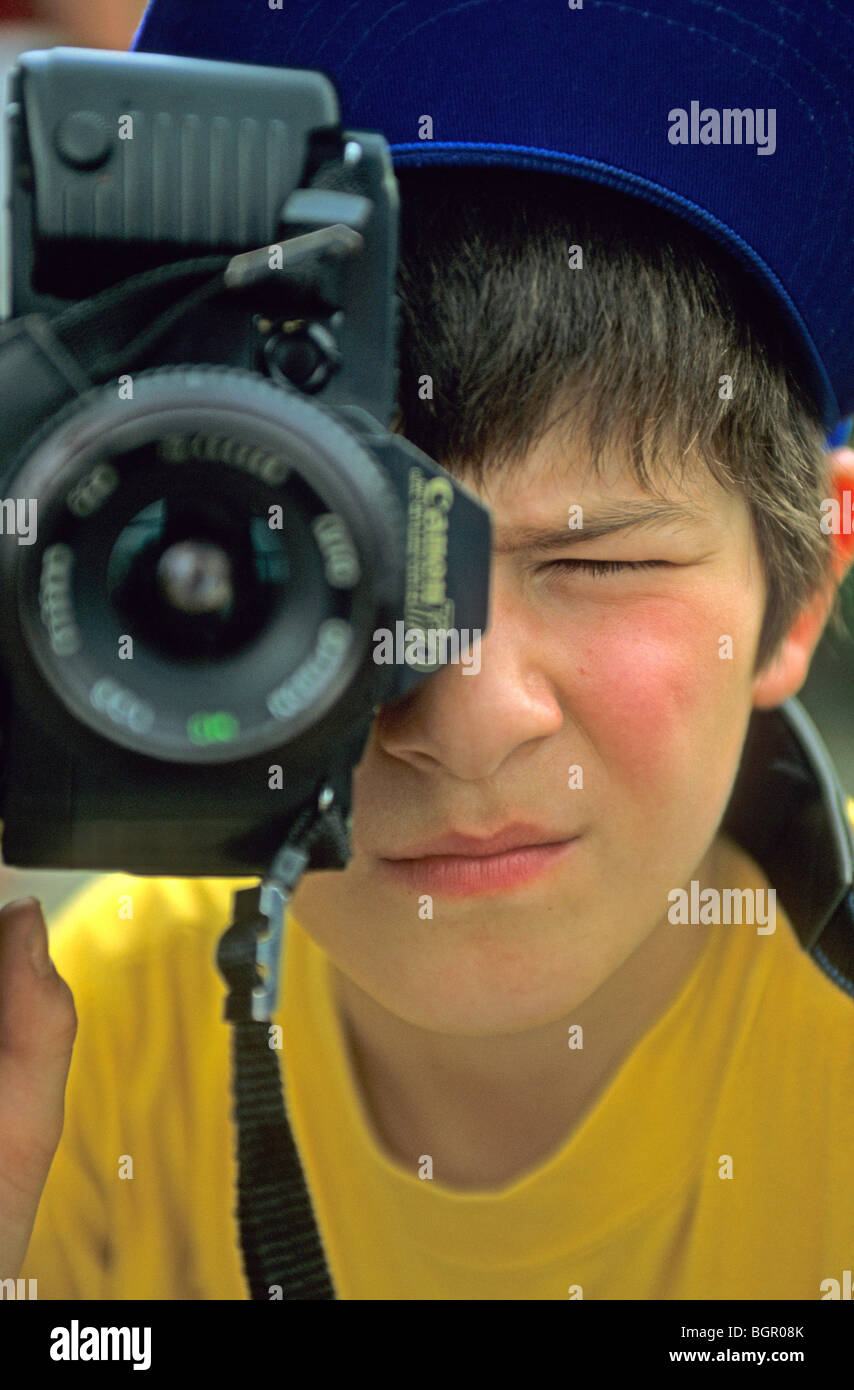 portrait of a young boy taking a photograph with a reflex camera Stock ...