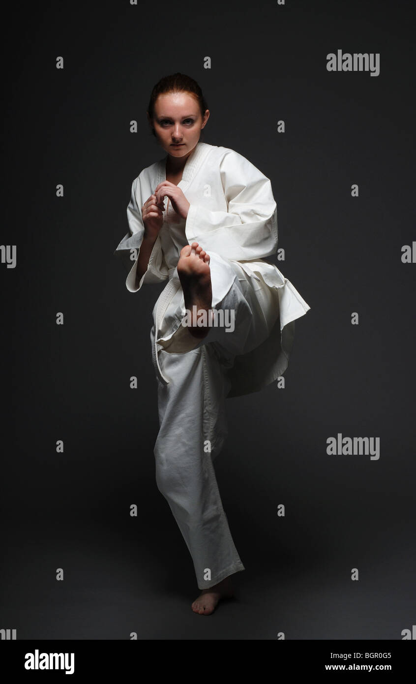 Girl in white kimono kicks forward left leg Stock Photo - Alamy
