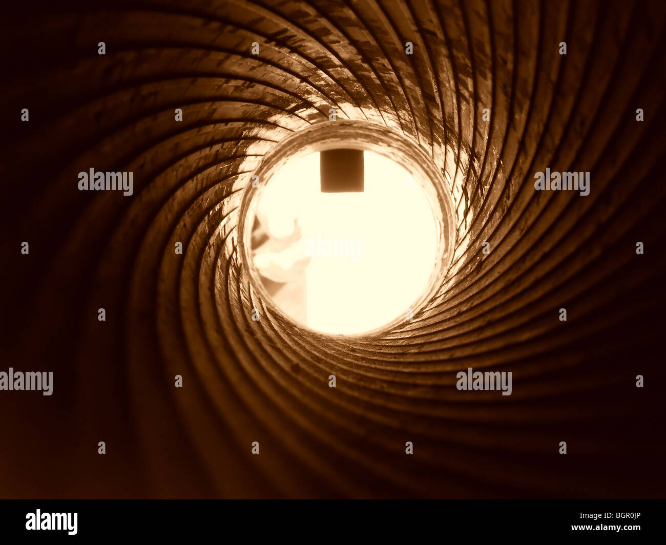 White disk with shiny steel spirals of rifling, view of cannon barrel ...