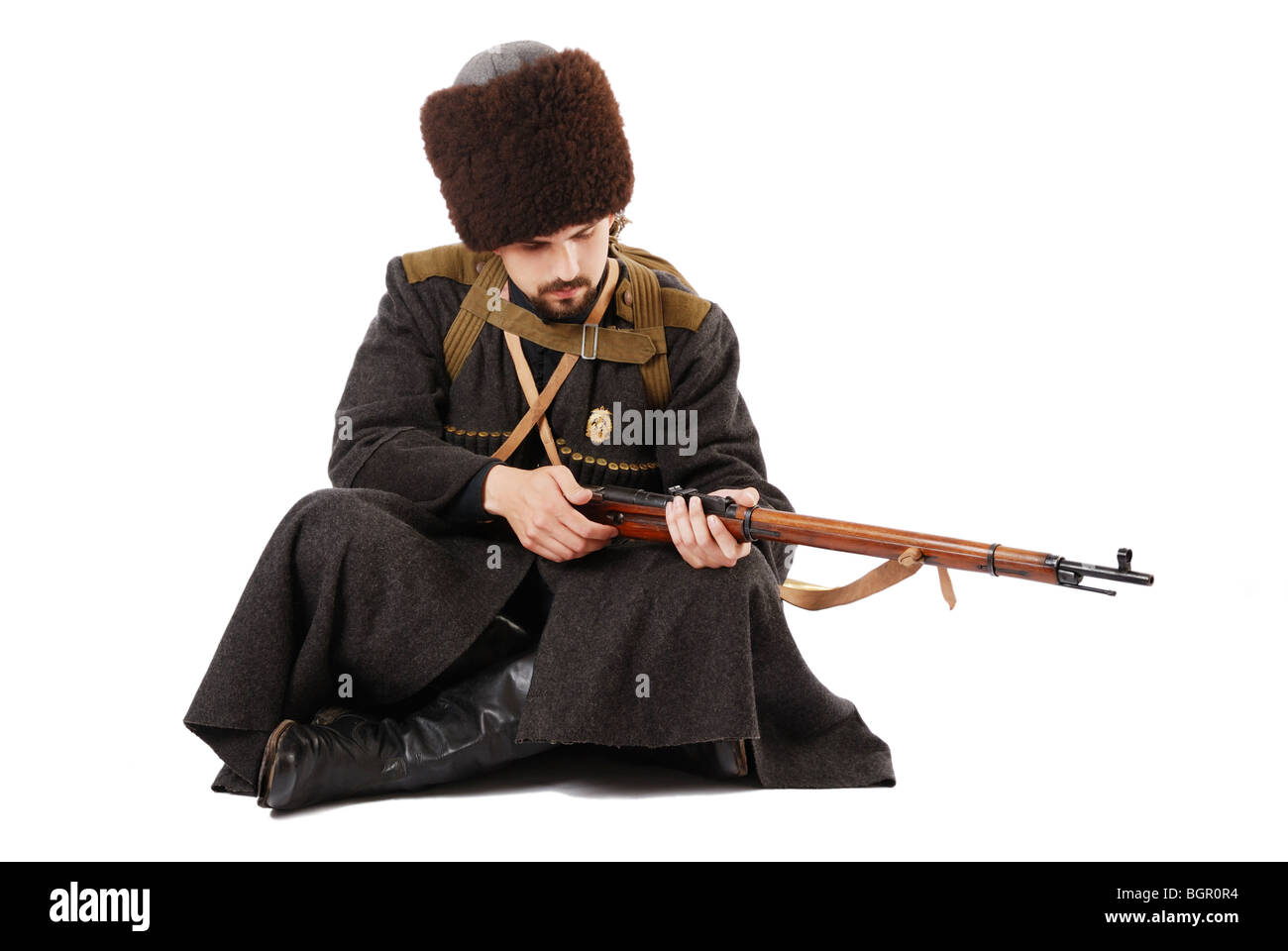 Russian Cossack inspecting a rifle in sitting position. The living ...