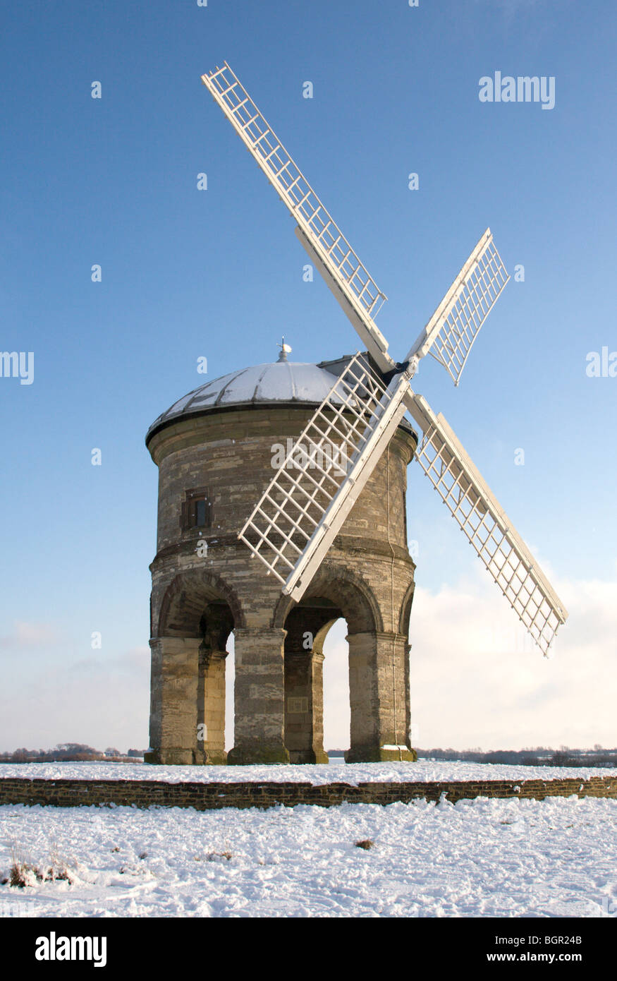 A portrait image of Chesterton Windmill in Warwickshire with snow on ...