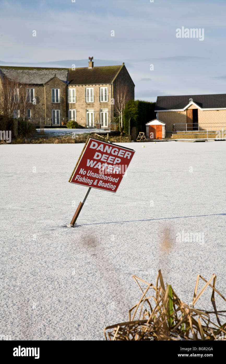 Danger, Deep Water sign on a frozen tarn Stock Photo - Alamy