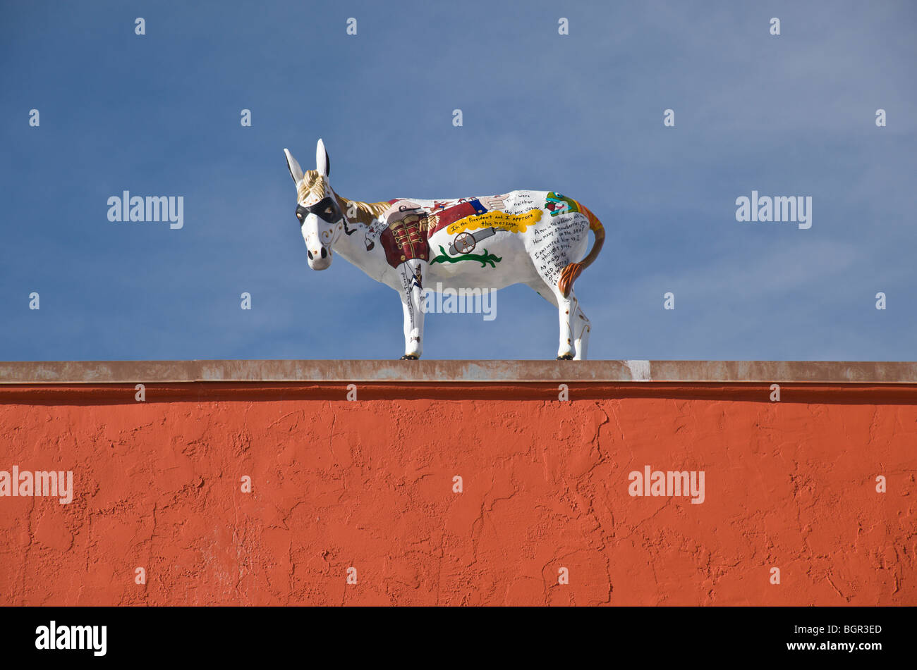 From high-atop an adobe building a famous painted burro watches over ...