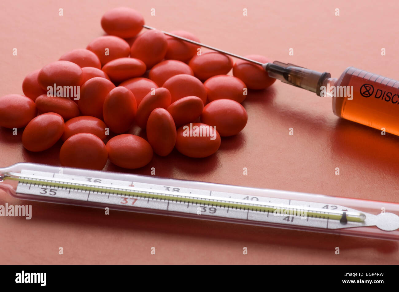 object on red - Medical Tablets and syringe close up Stock Photo - Alamy
