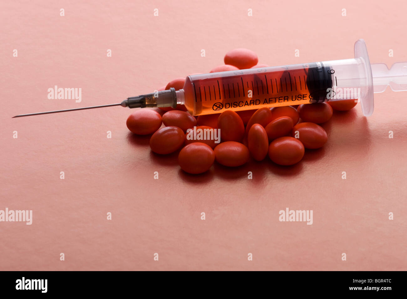 object on red - Medical Tablets and syringe close up Stock Photo - Alamy
