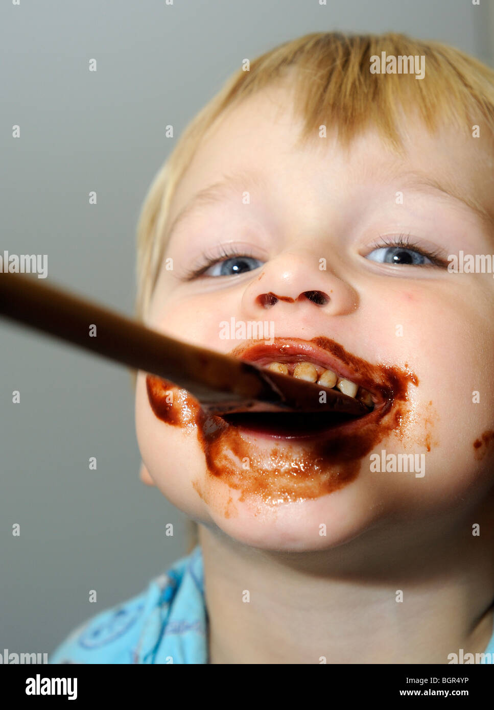 young child blond boy with chocolate smeared all over face Stock Photo ...