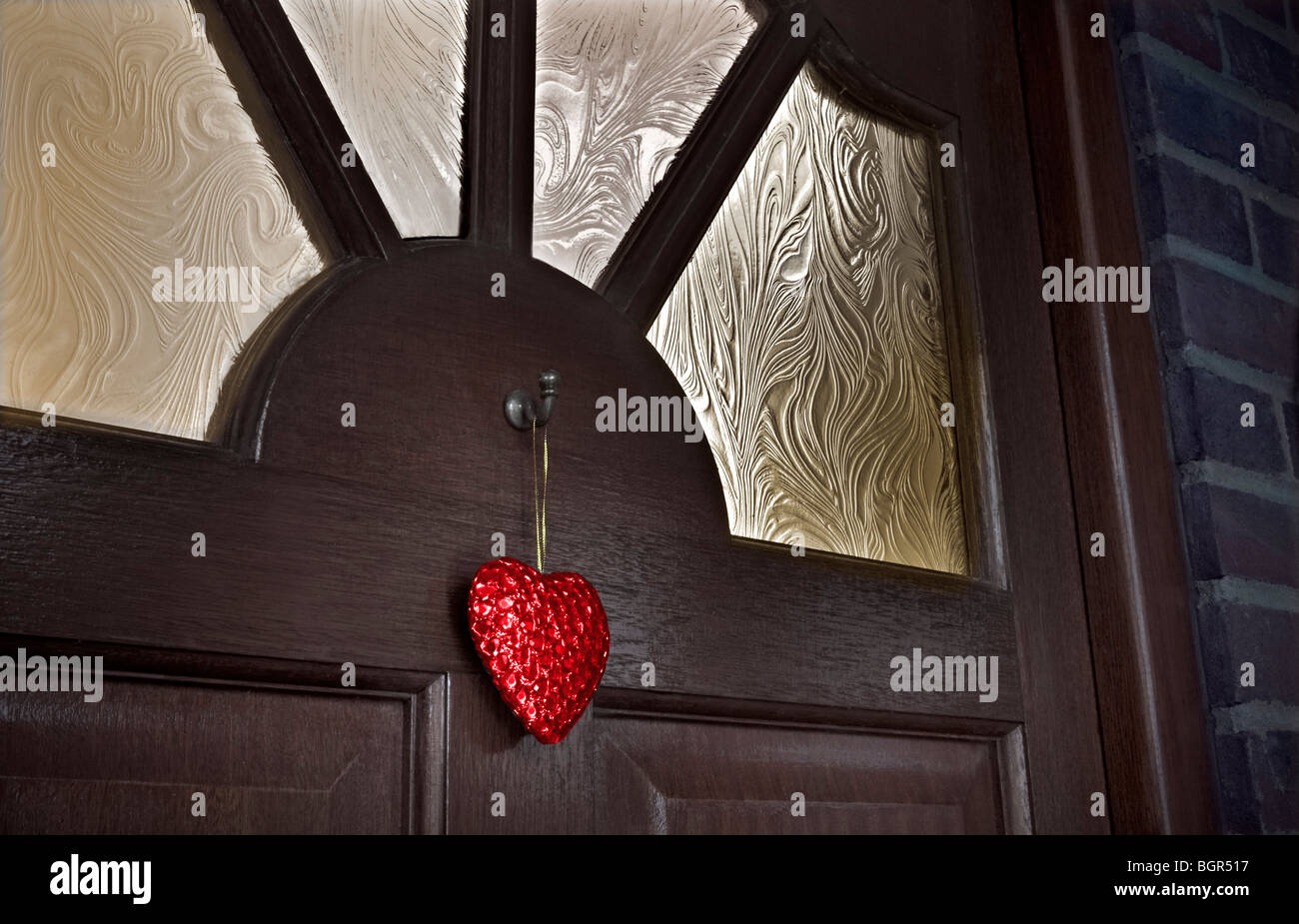 HOME HEART LOVE FRONT DOOR CONCEPT Glittering heart emblem hanging on ...