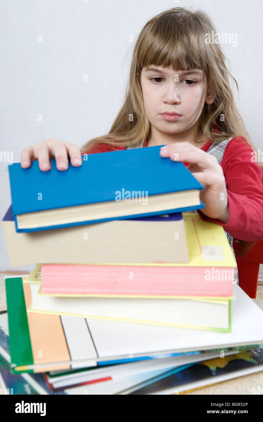 Is it possible to read all these books? little cute sad girl with a ...