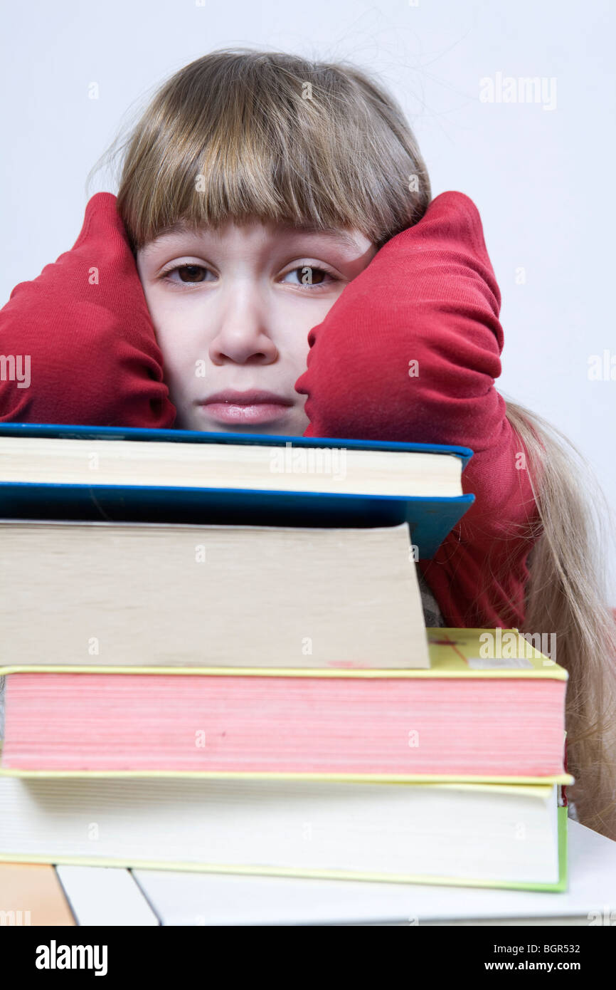 Is it possible to read all these books? little cute sad girl with a ...
