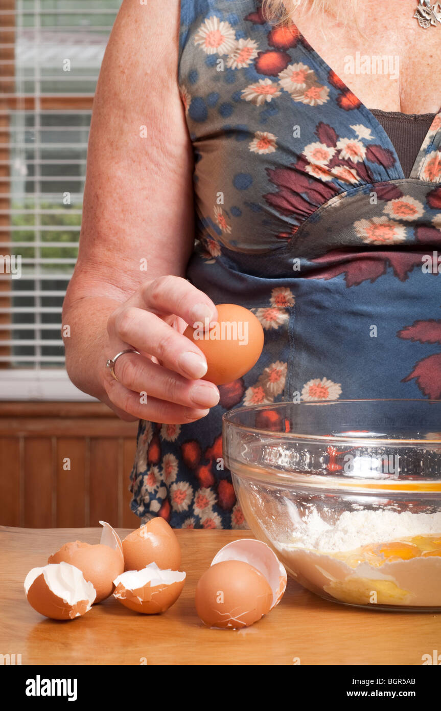 Woman breaking eggs model released hi-res stock photography and images - Alamy