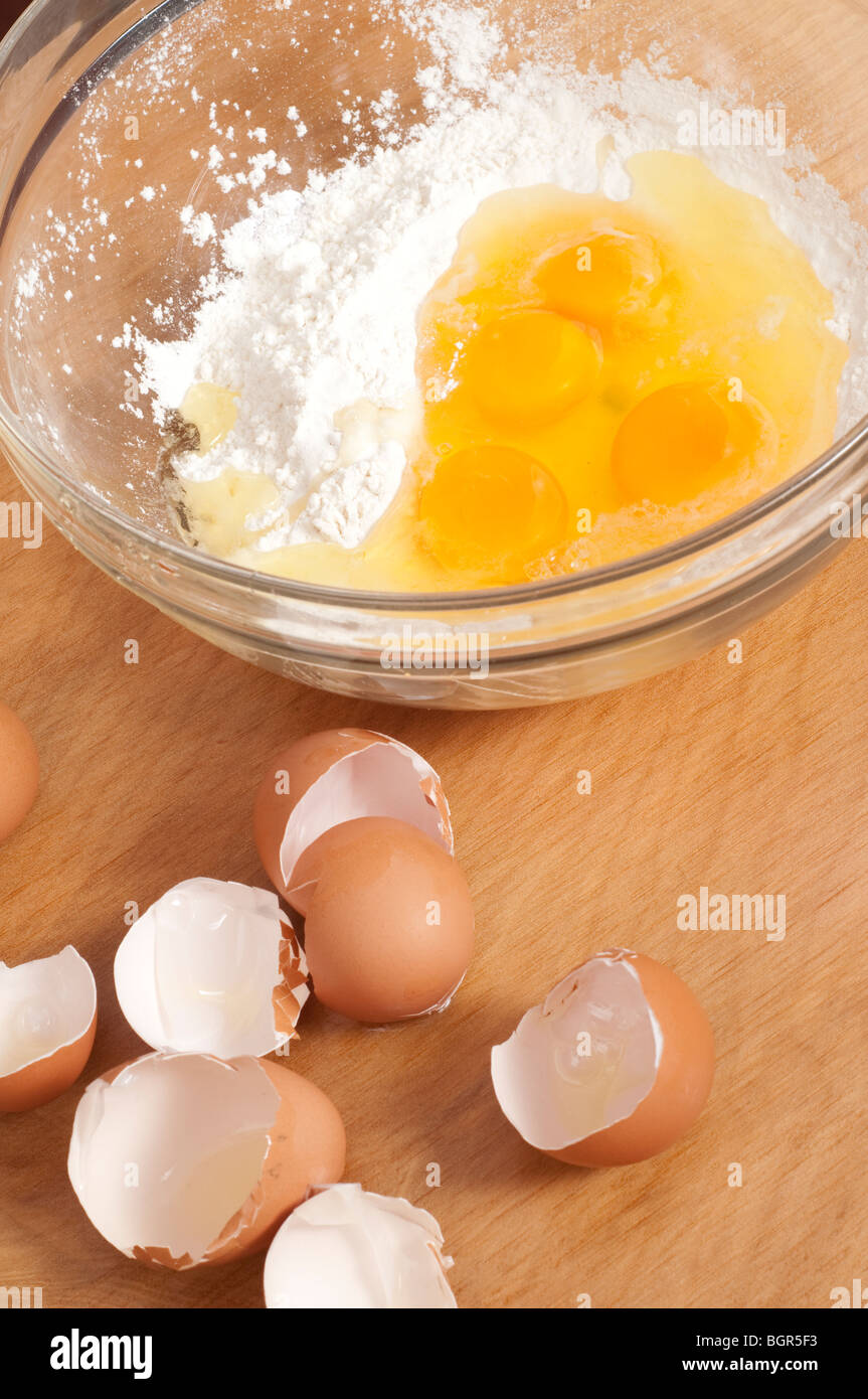 Mixing bowl of flour with eggs shells Stock Photo - Alamy