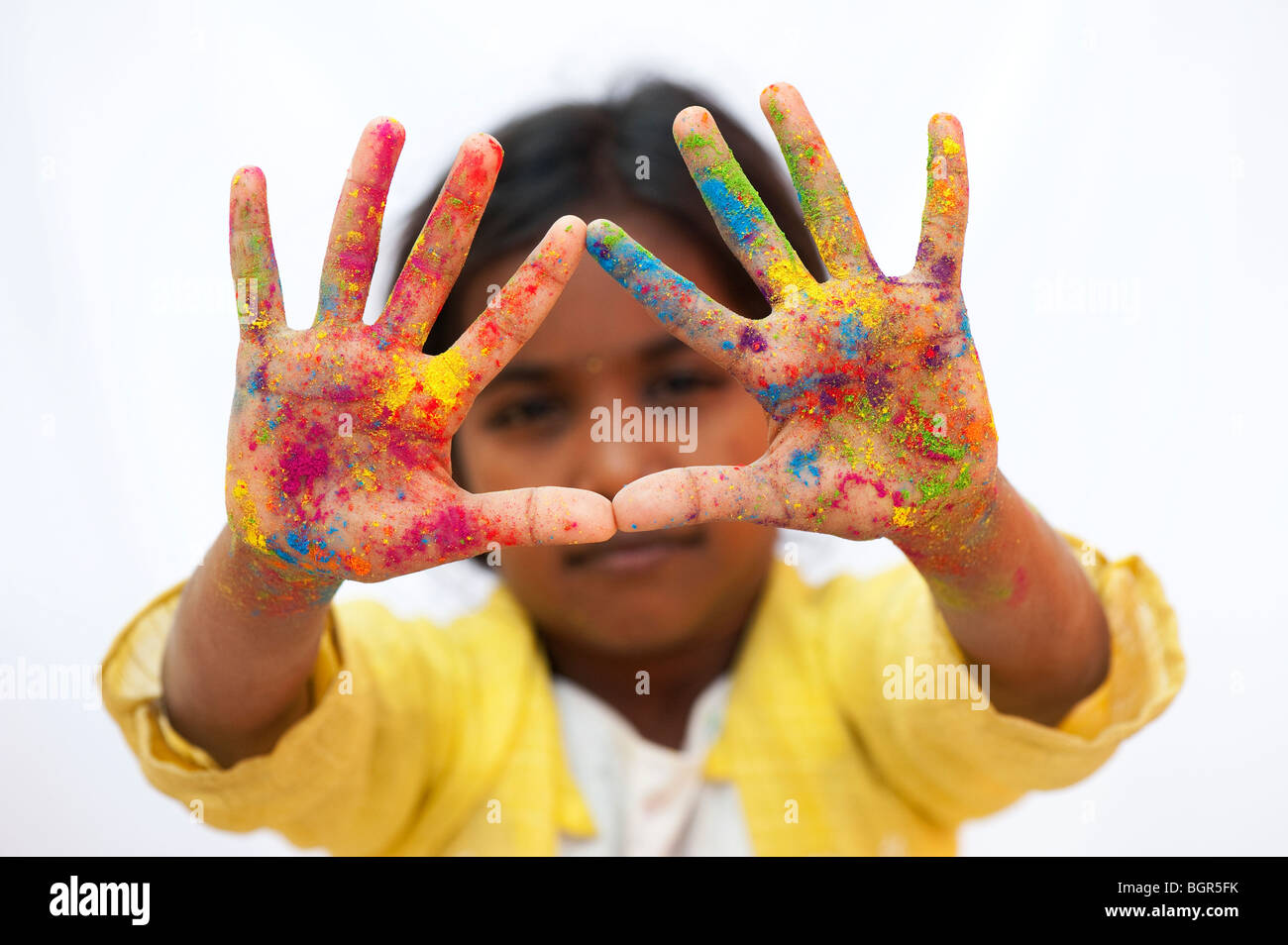 Young Indian girl with coloured powder on her hands. India Stock Photo ...