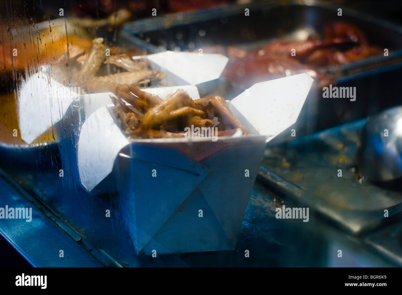 Chinese food containers through the window of a Chinatown restaurant ...