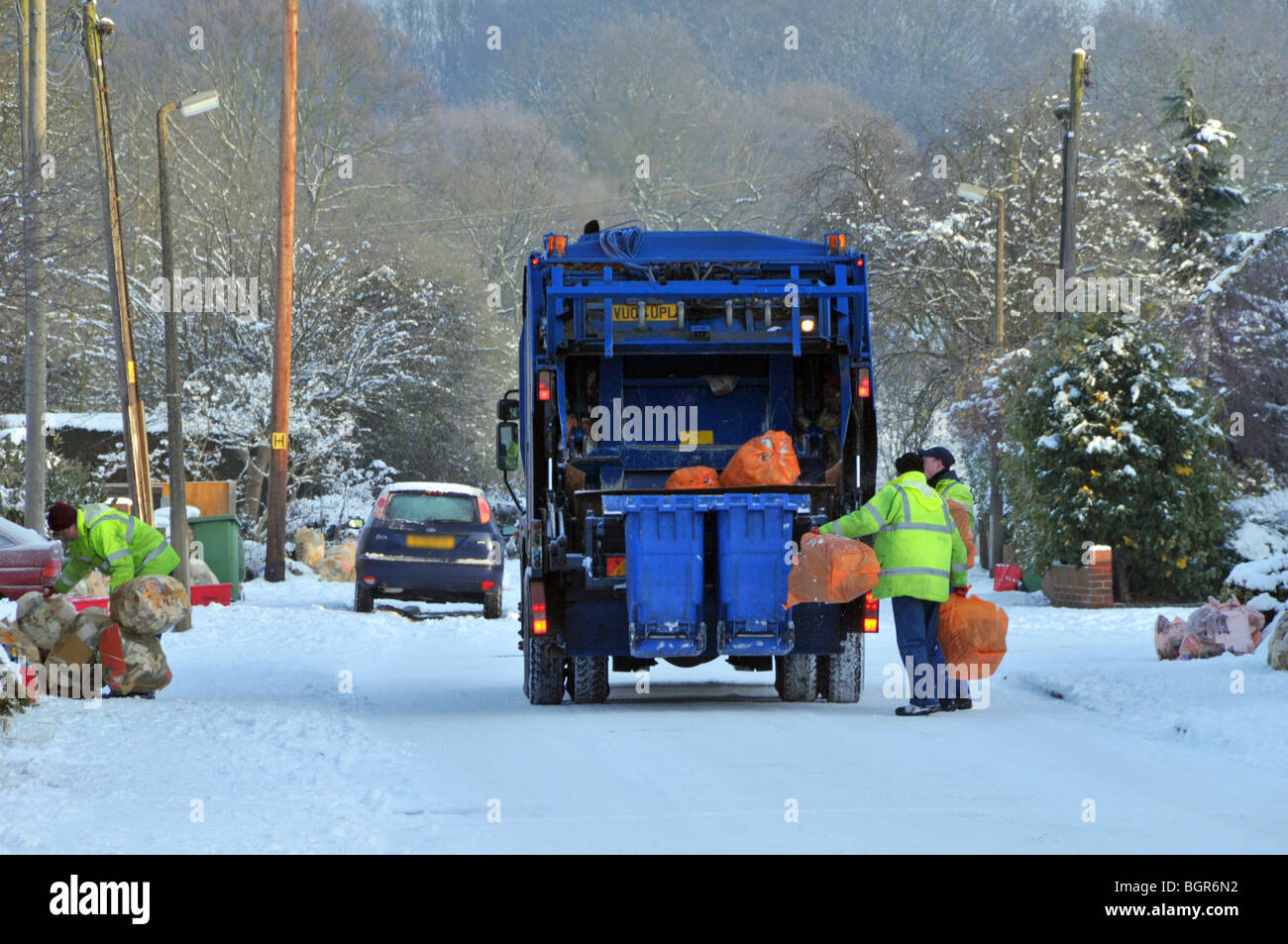 Dustcart lorry and binmen on icy snow covered residential road Stock ...