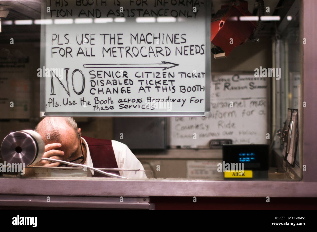 An attendant in a booth at a New York City subway station Stock Photo ...