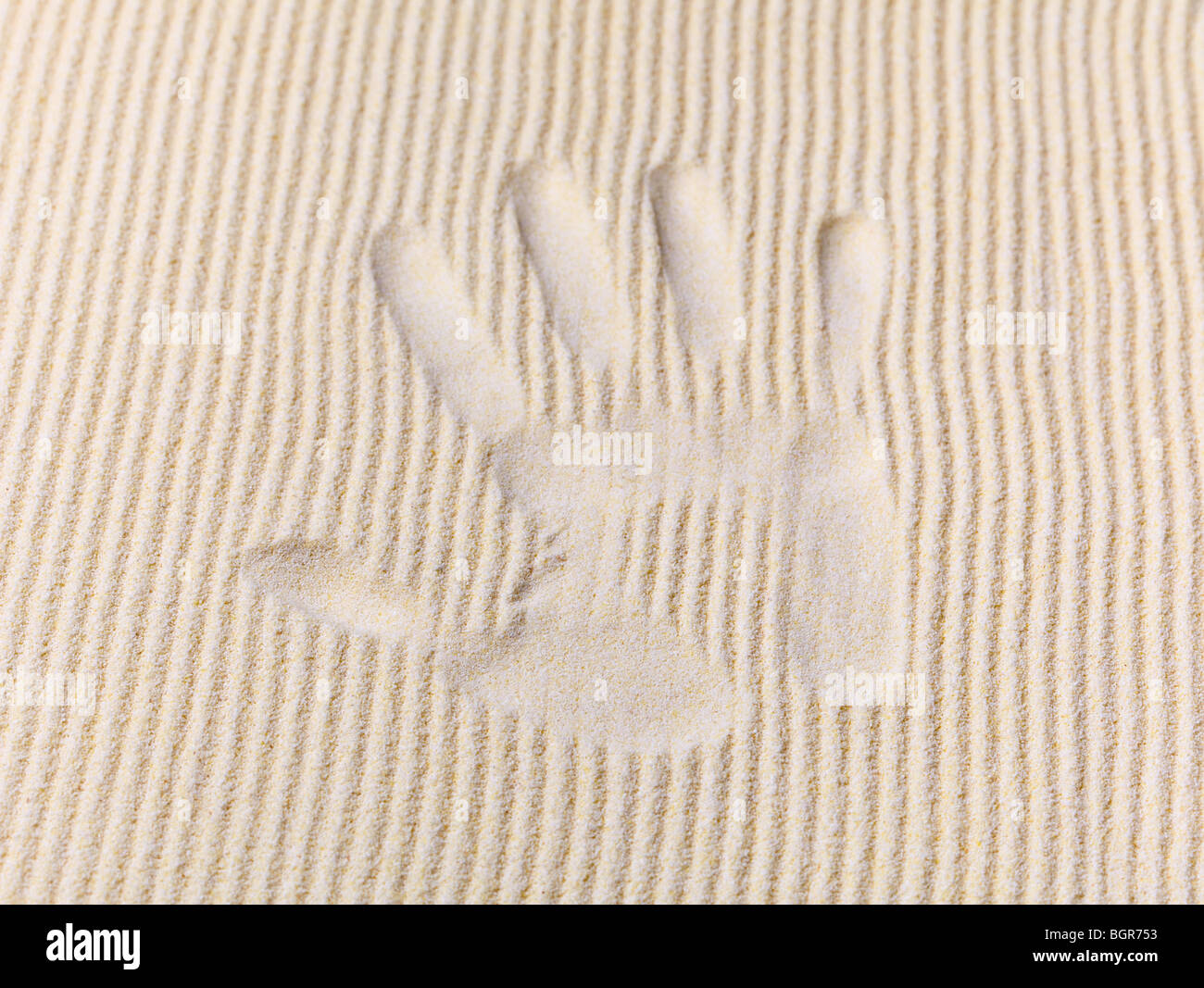 Trace from a palm on a sand surface Stock Photo - Alamy