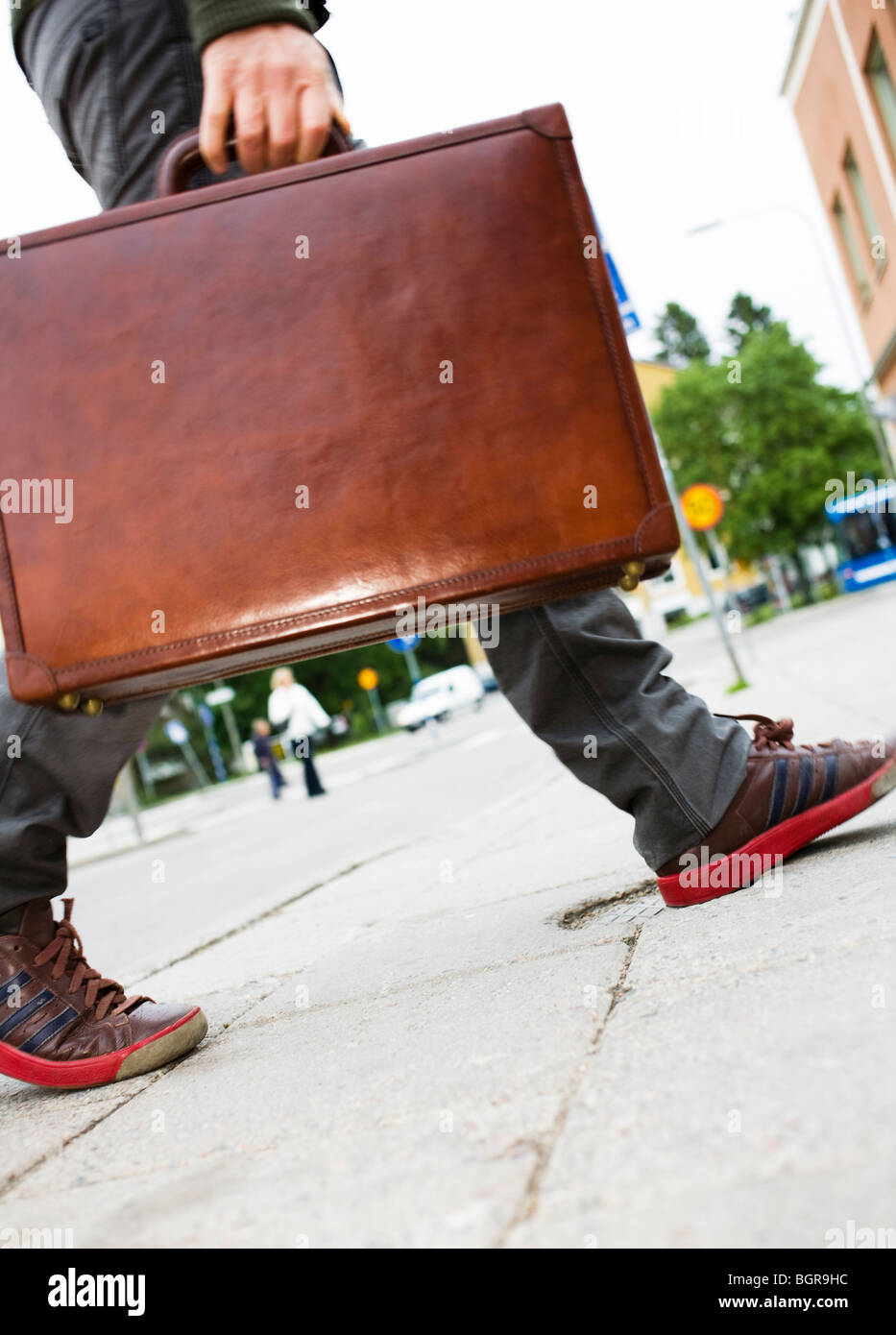 Man wearing sneakers and carrying a briefcase, Sweden Stock Photo - Alamy