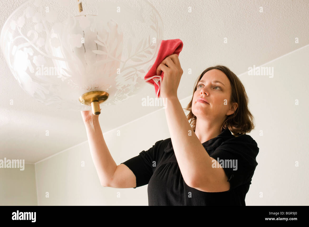 Woman dusting a lamp hi-res stock photography and images - Alamy