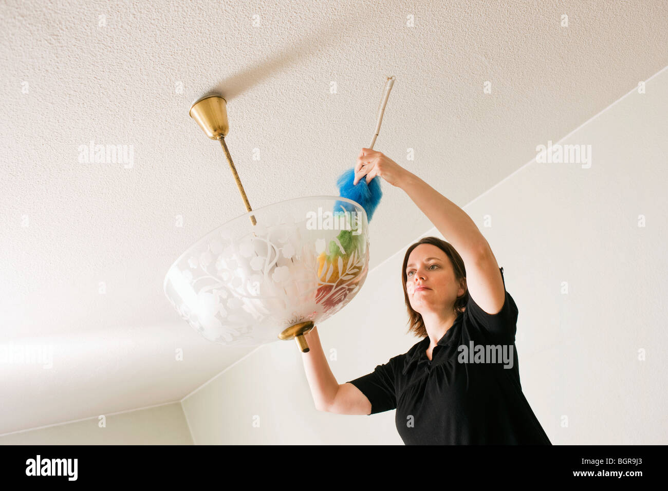 Woman dusting a lamp hi-res stock photography and images - Alamy