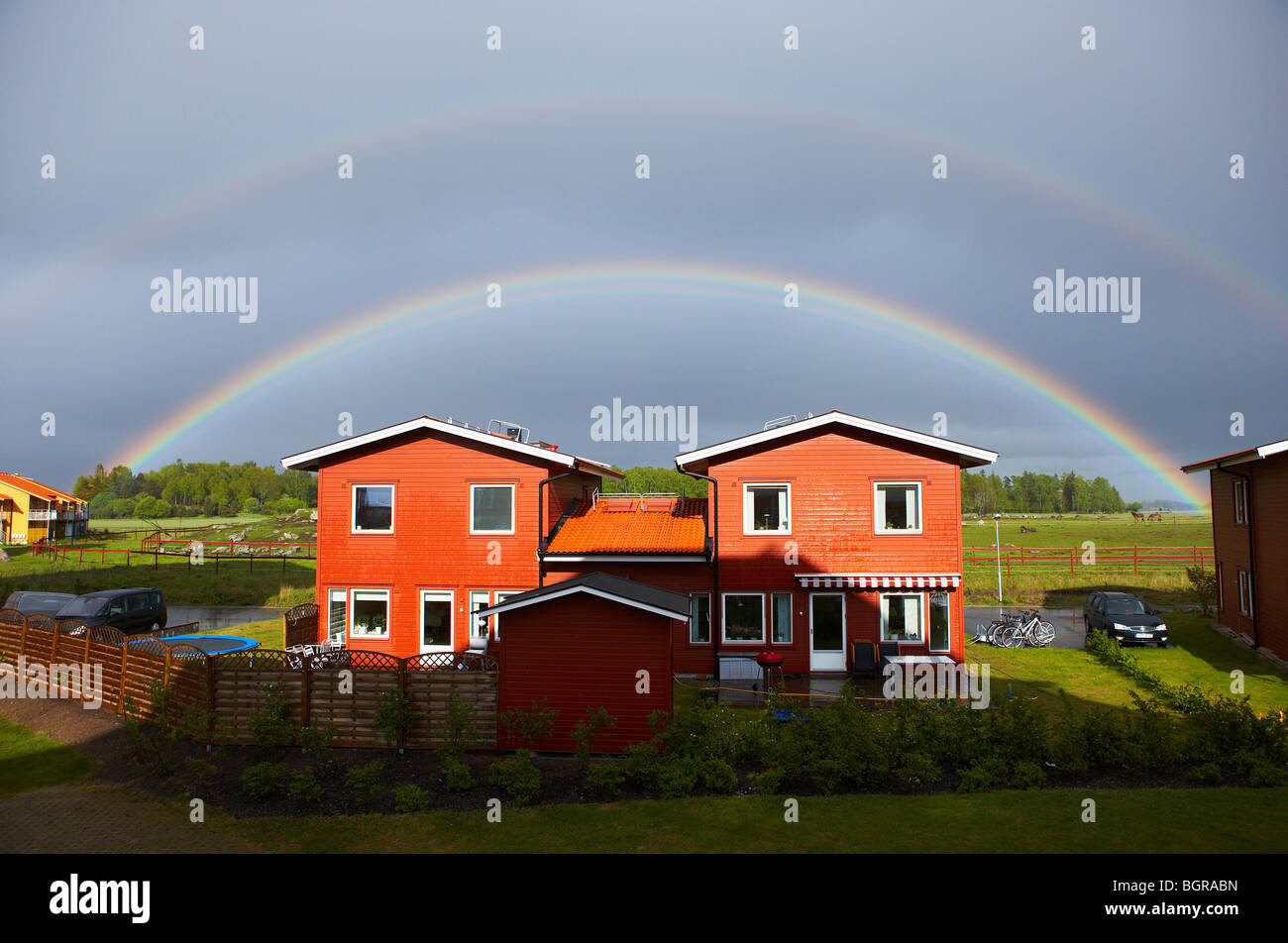 Rainbow over houses, Sweden Stock Photo - Alamy