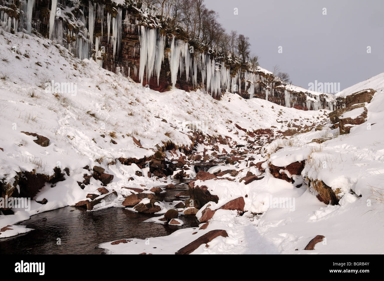 Snow covered stream and icicles Pont ar Daf Storey Arms Brecon Beacons ...