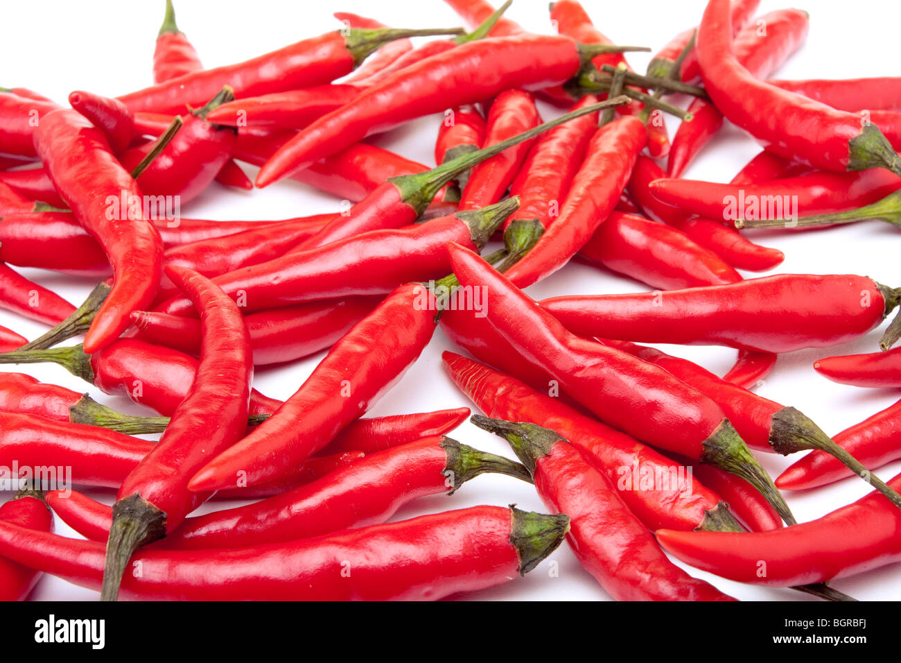A group of red hot chilli peppers over white background / texture Stock ...