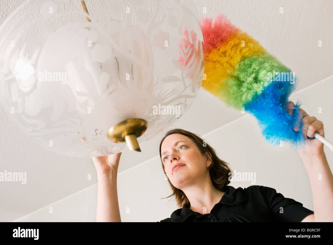 Woman dusting a lamp hi-res stock photography and images - Alamy