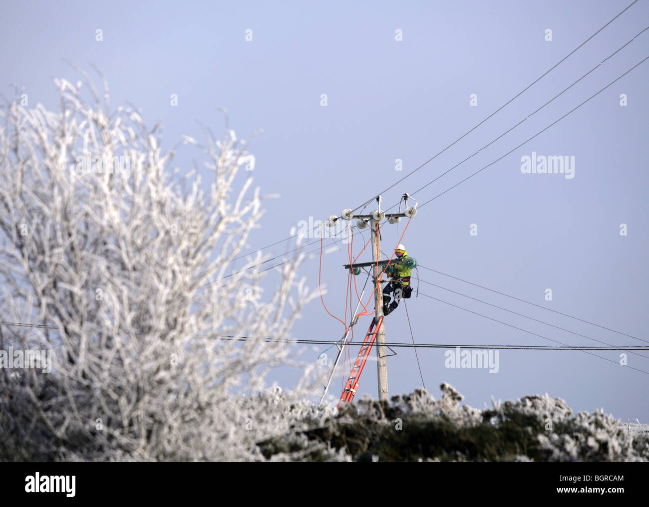 Worker working on frozen power lines Stock Photo - Alamy