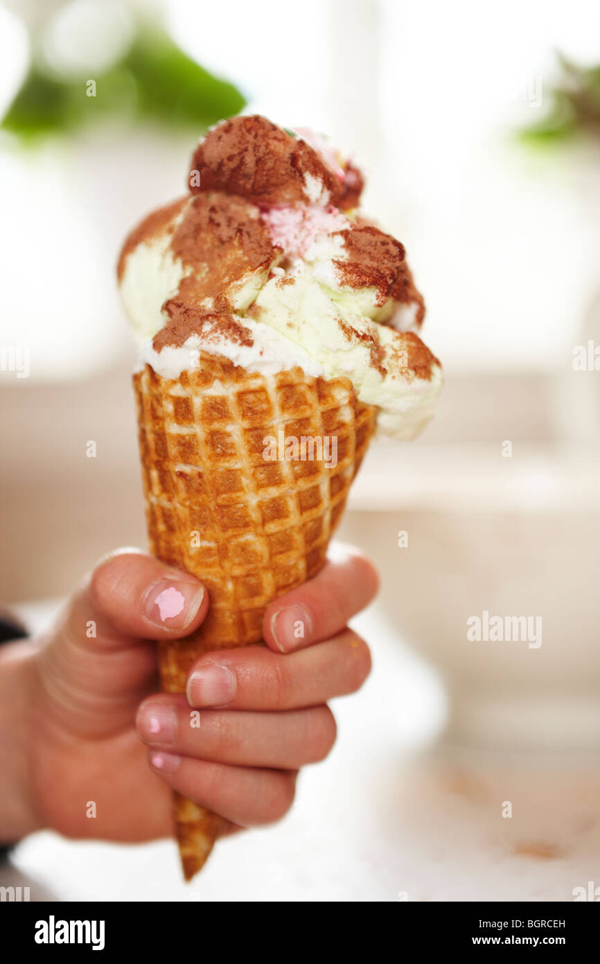 A hand holding an ice cream, close-up Stock Photo - Alamy
