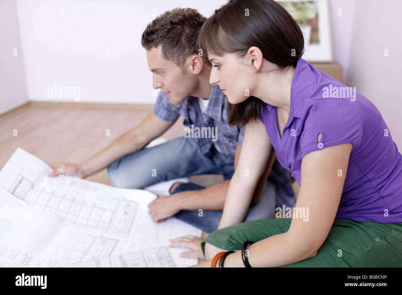 man and woman in an empty apartment making plans Stock Photo - Alamy