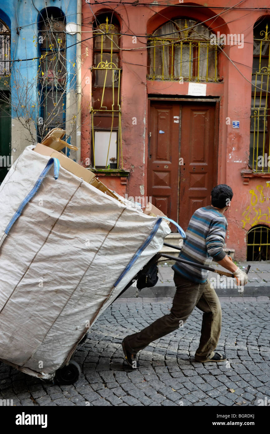 A worker which recycles the waste from trash beans is carrying paper ...