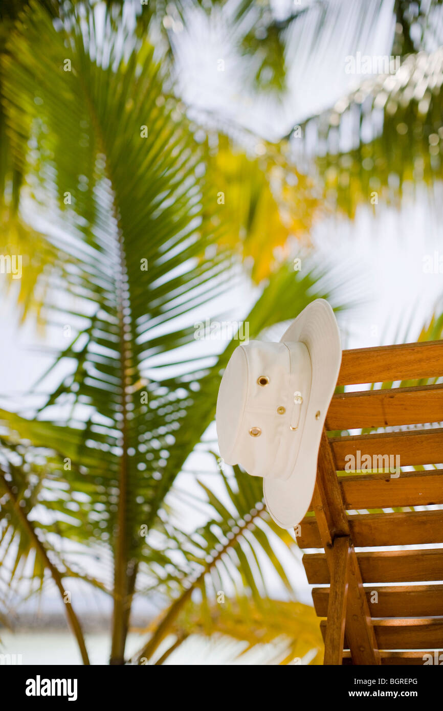 A sun hat hanging on a sun chair, the Maldives Stock Photo - Alamy