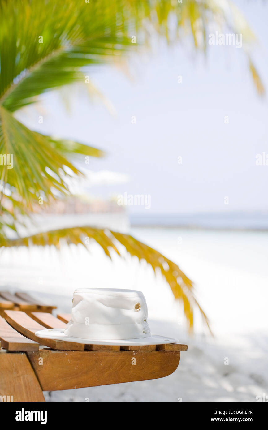 A hat on a sun chair, the Maldives Stock Photo - Alamy