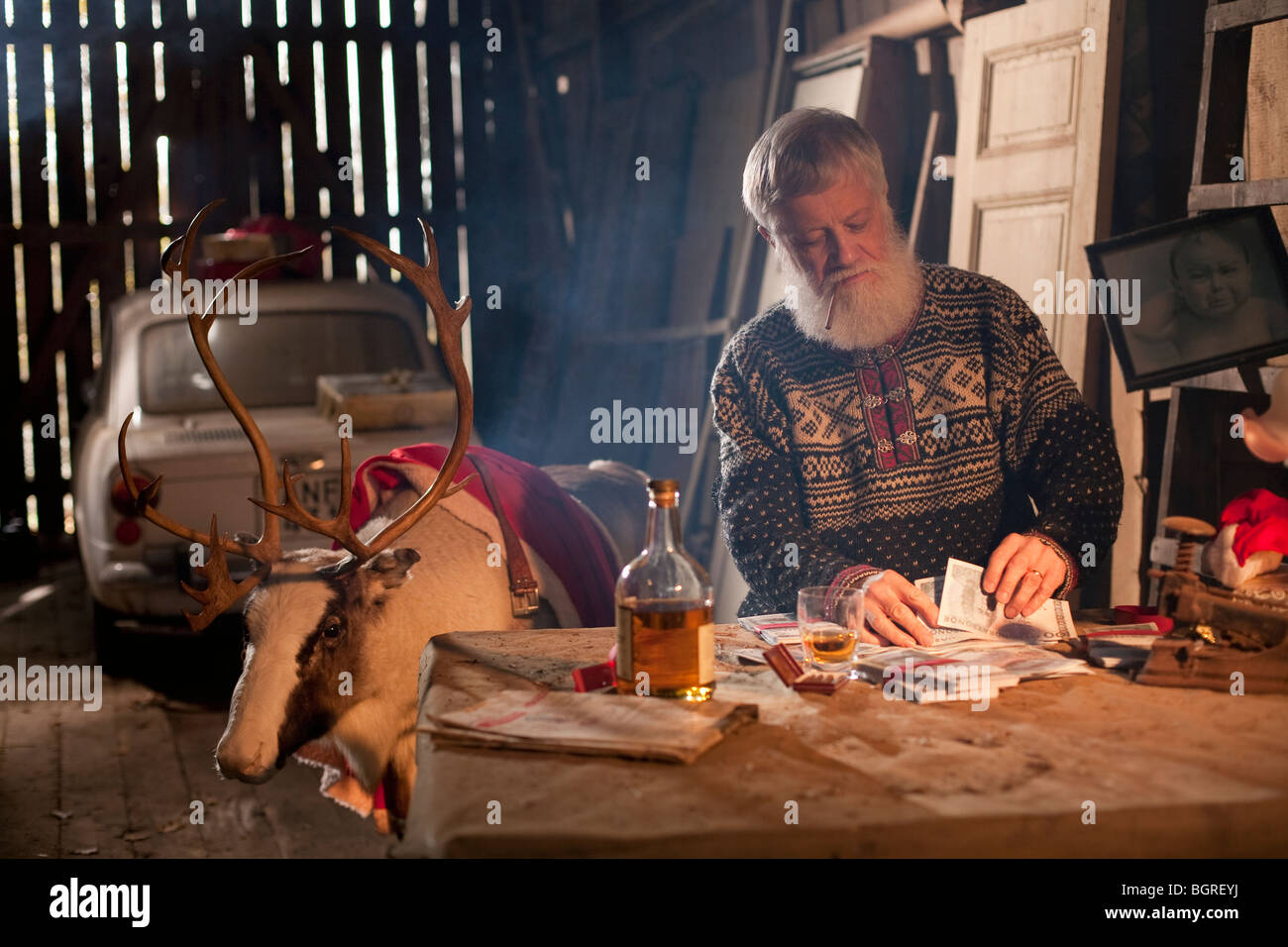 Santa Claus in a barn with a reindeer, Sweden Stock Photo - Alamy