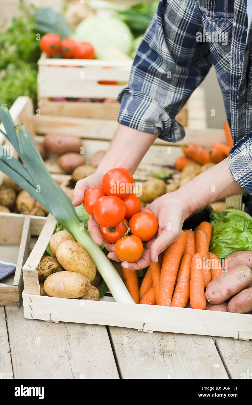 Man carrying a box of vegetables Stock Photo - Alamy
