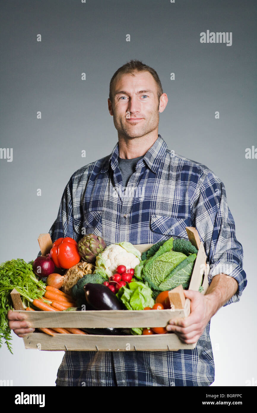 Man holding a box of vegetables Stock Photo - Alamy