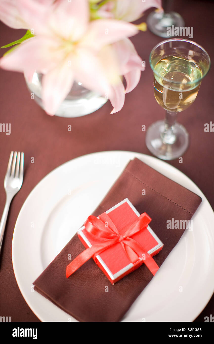 Table laid with a little red box on a plate Stock Photo - Alamy