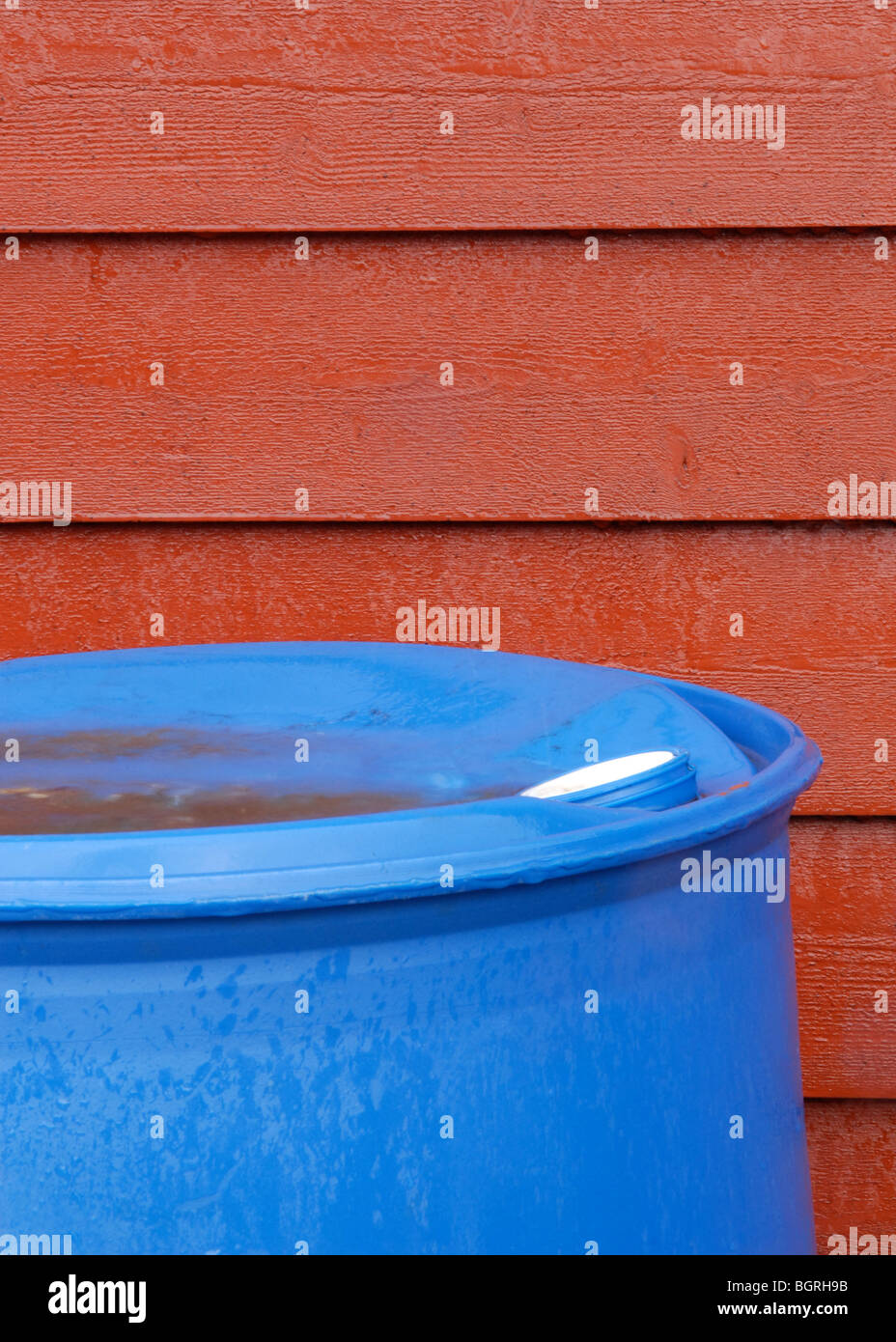 A bright blue bin on a rusty coloured wooden background Stock Photo - Alamy