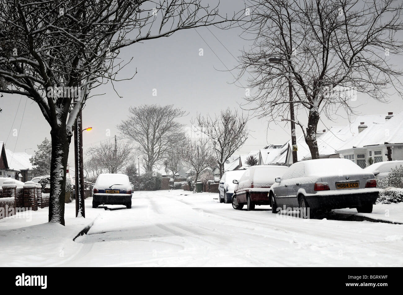 Suburban road covered in thick snow Stock Photo - Alamy