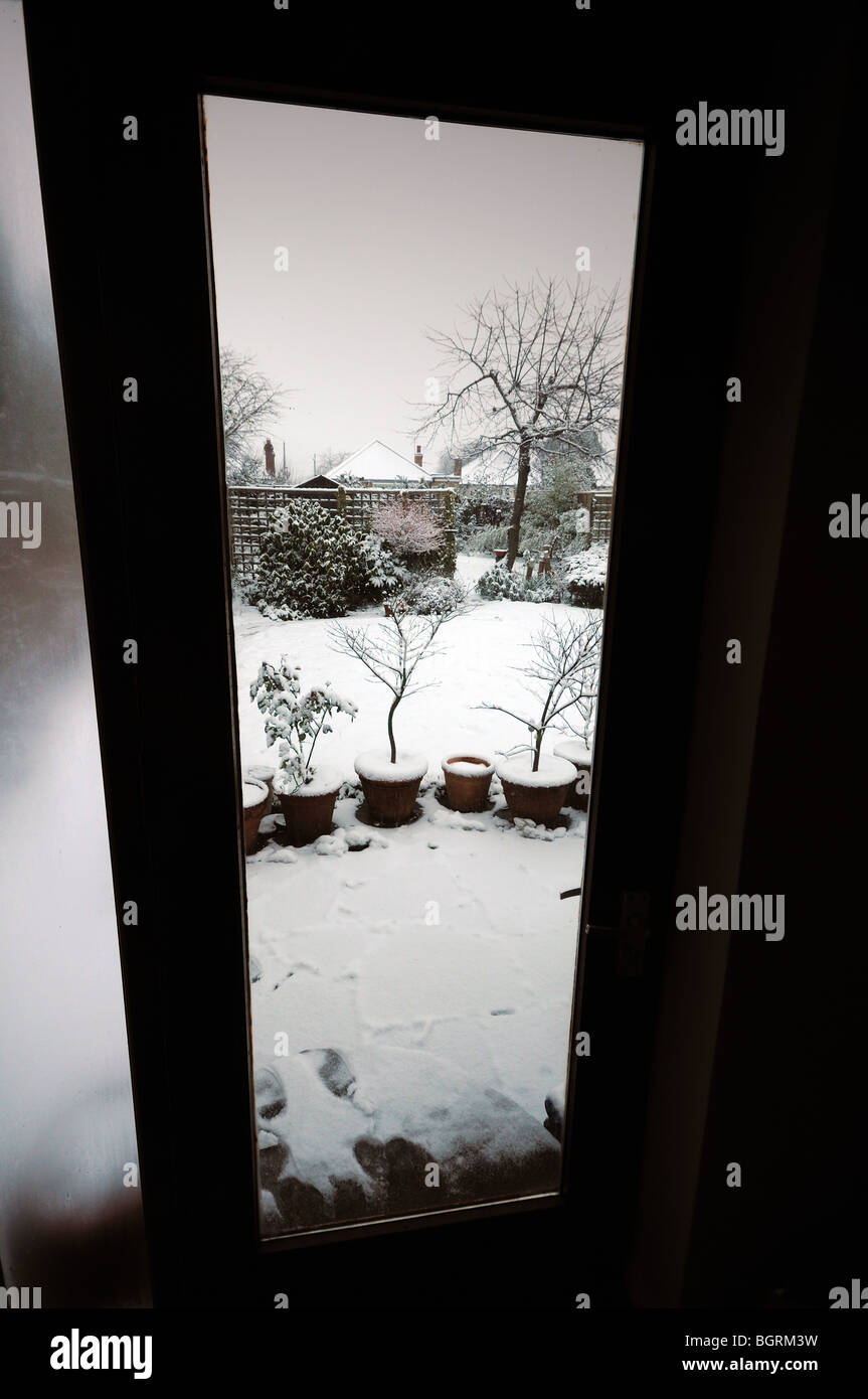 Winter snow through house back door Stock Photo - Alamy