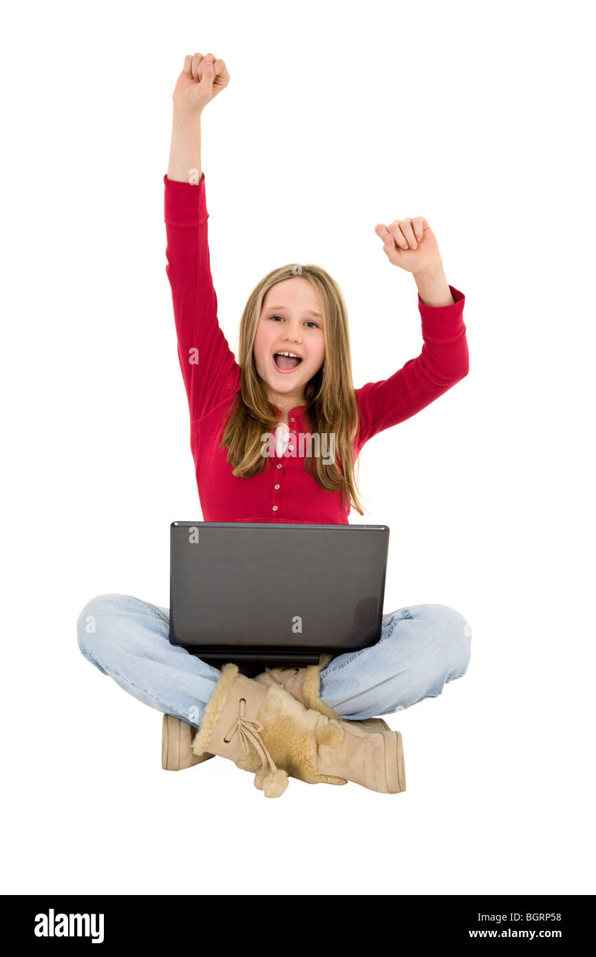 Child sitting on a white background with a laptop computer Stock Photo ...