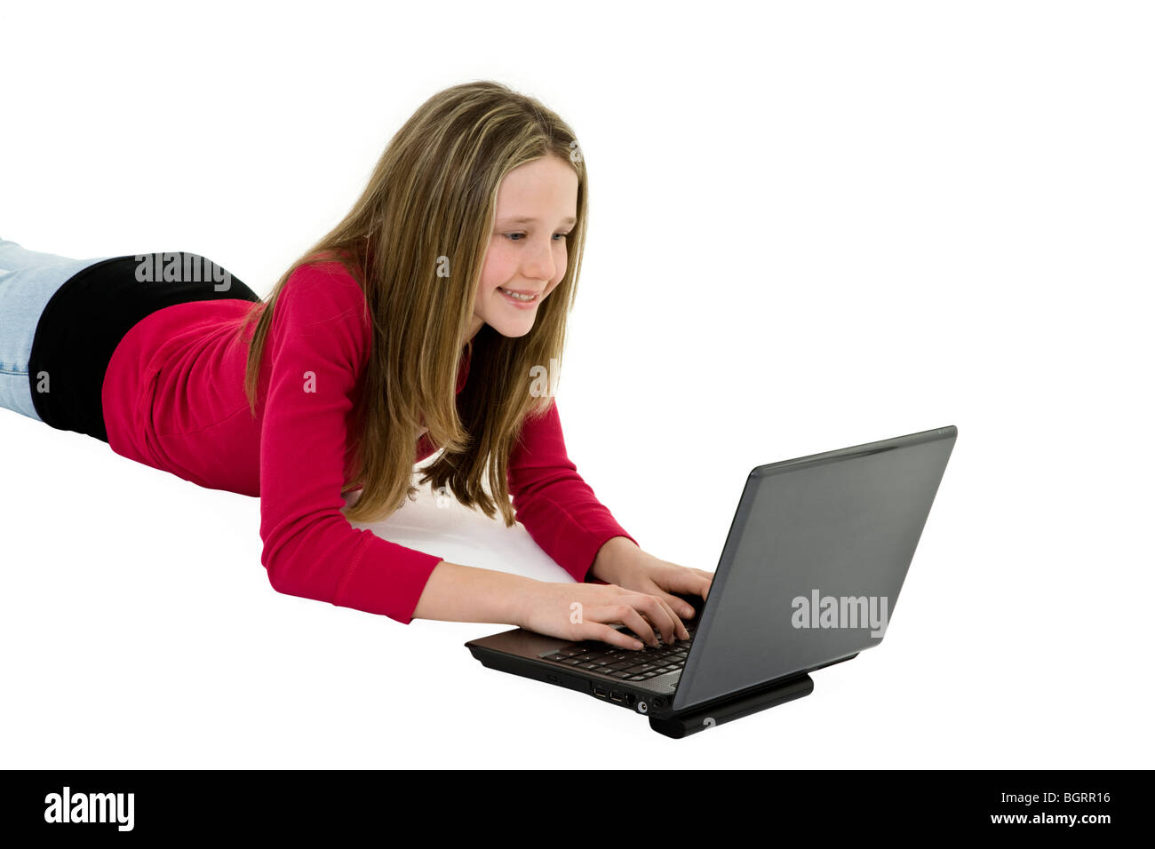 Child laying on a white background working on laptop computer Stock ...
