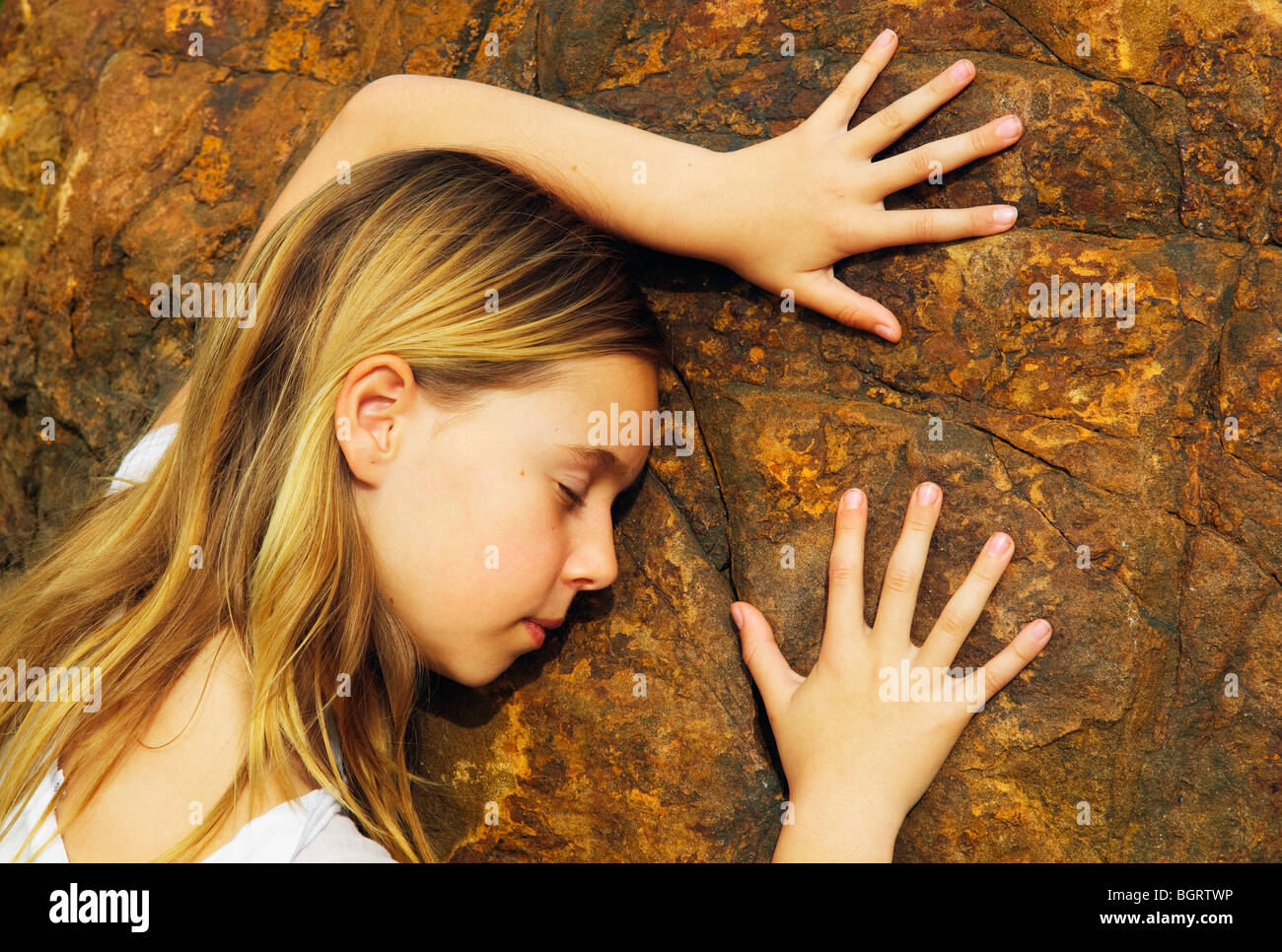 Child touching a rock Stock Photo - Alamy