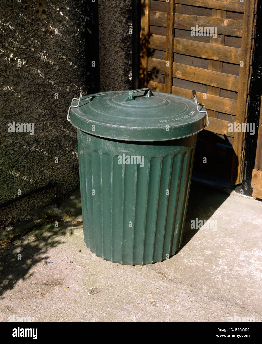 Green plastic garbage can Stock Photo - Alamy