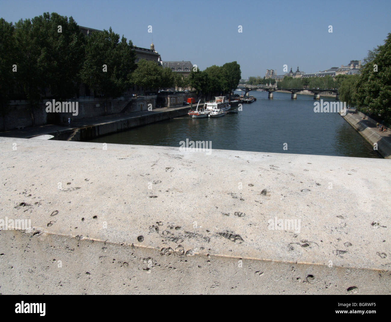 Building stone with fossils and Seine river view Pont Neuf. Paris ...