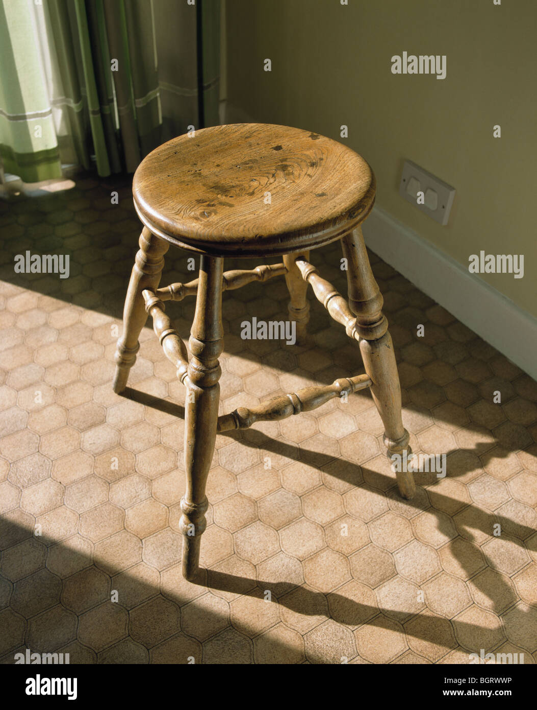 Stool in corner of room Stock Photo - Alamy