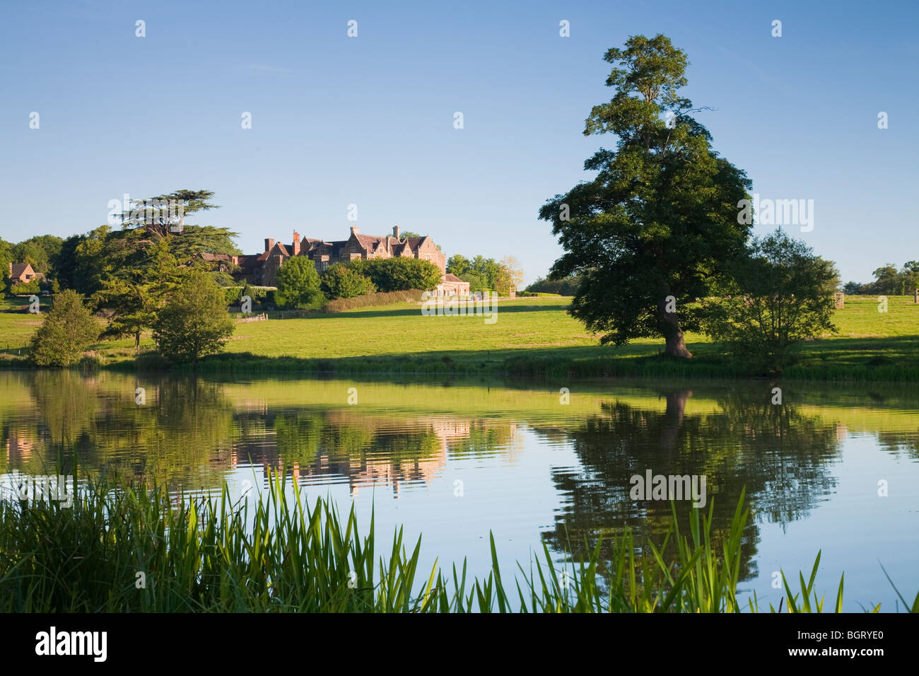 Fawsley Hall Hotel seen across the lake Stock Photo - Alamy